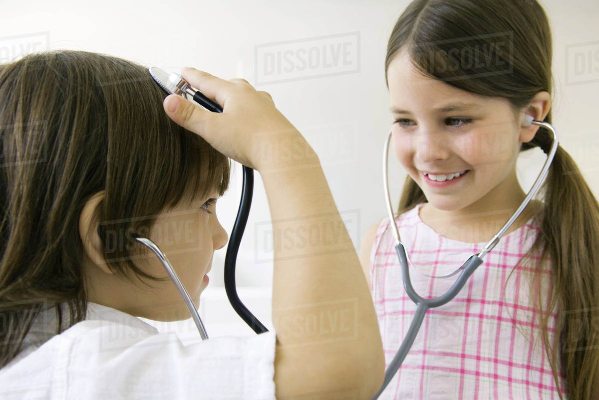 Children playing with stethoscopes - Stock Photo - Dissolve