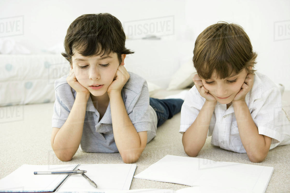 Two boys lying on floor, studying homework - Royalty-free Stock Photo ...