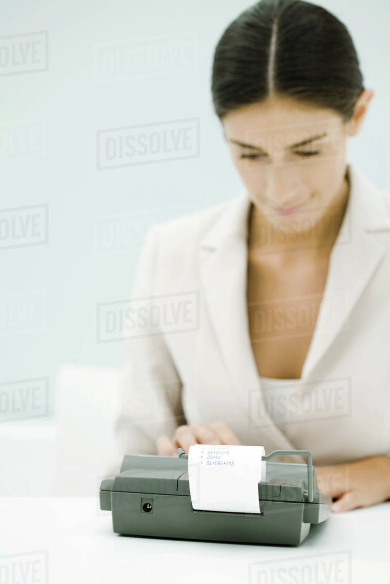 Female accountant using adding machine, looking down - Royalty-free ...