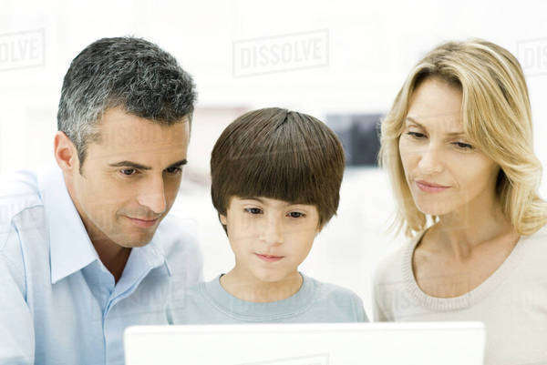 Family looking at laptop computer together, close-up - Royalty-free ...