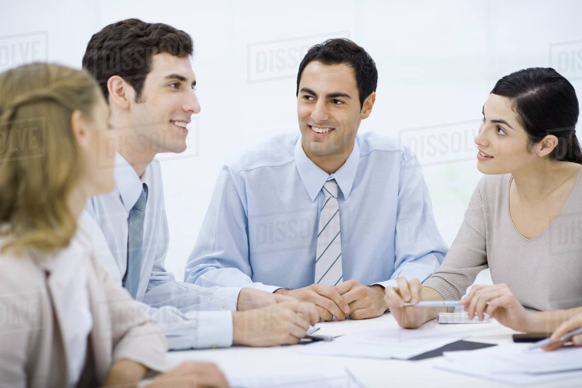 Businessman sitting with colleagues at conference table - Stock Photo ...