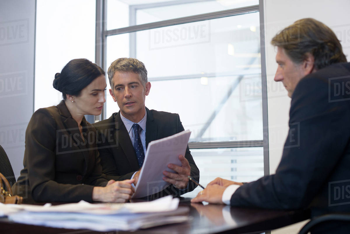 Business meeting, business associates reviewing contract - Stock Photo ...