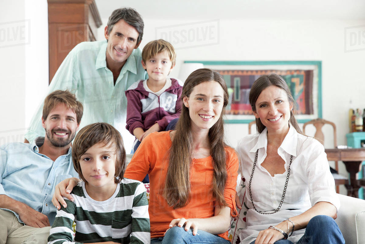 Family together in living room, portrait - Stock Photo - Dissolve