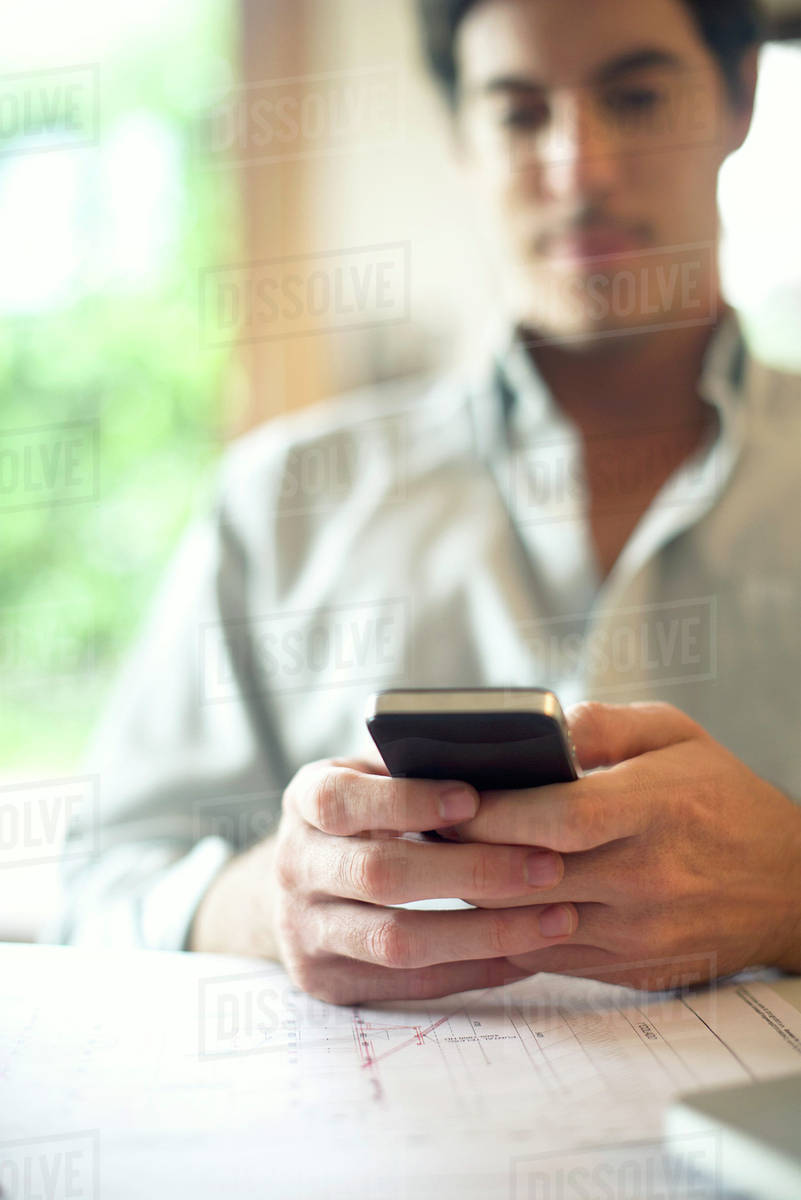 Man using smartphone - Stock Photo - Dissolve