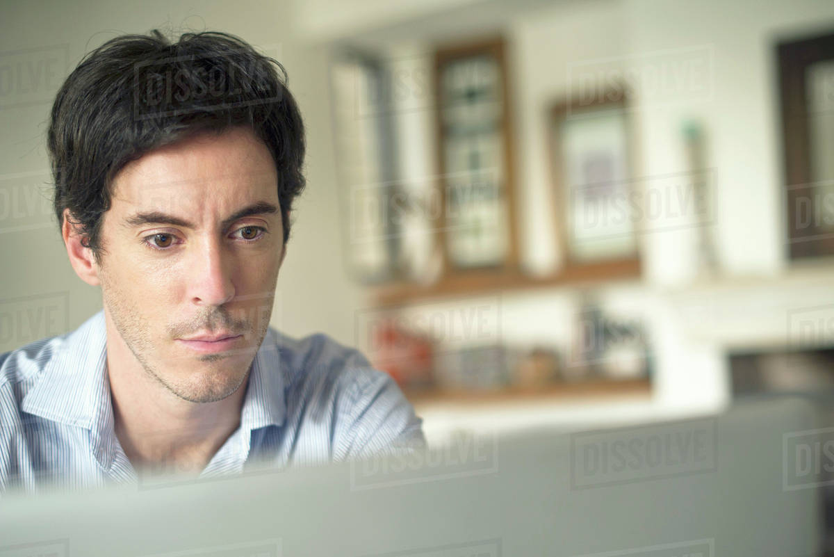 Man staring at laptop computer - Royalty-free Stock Photo | Dissolve