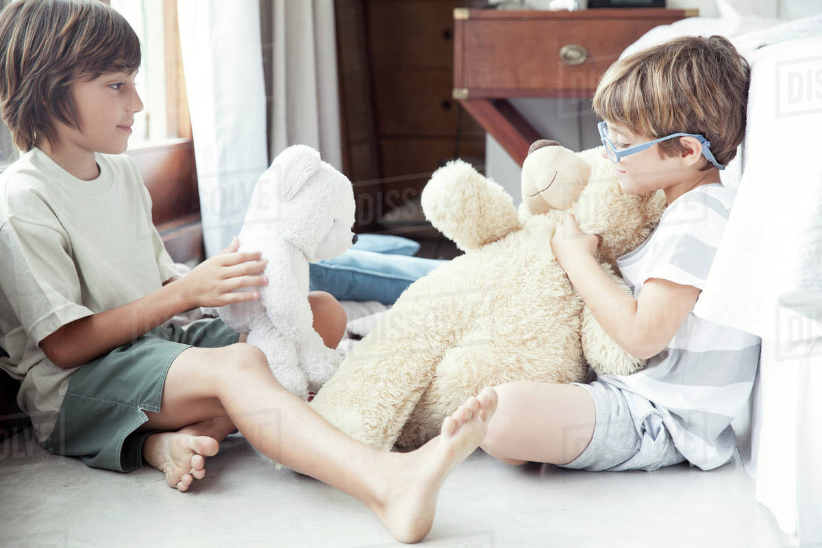 Boys playing with stuffed toys - Stock Photo - Dissolve