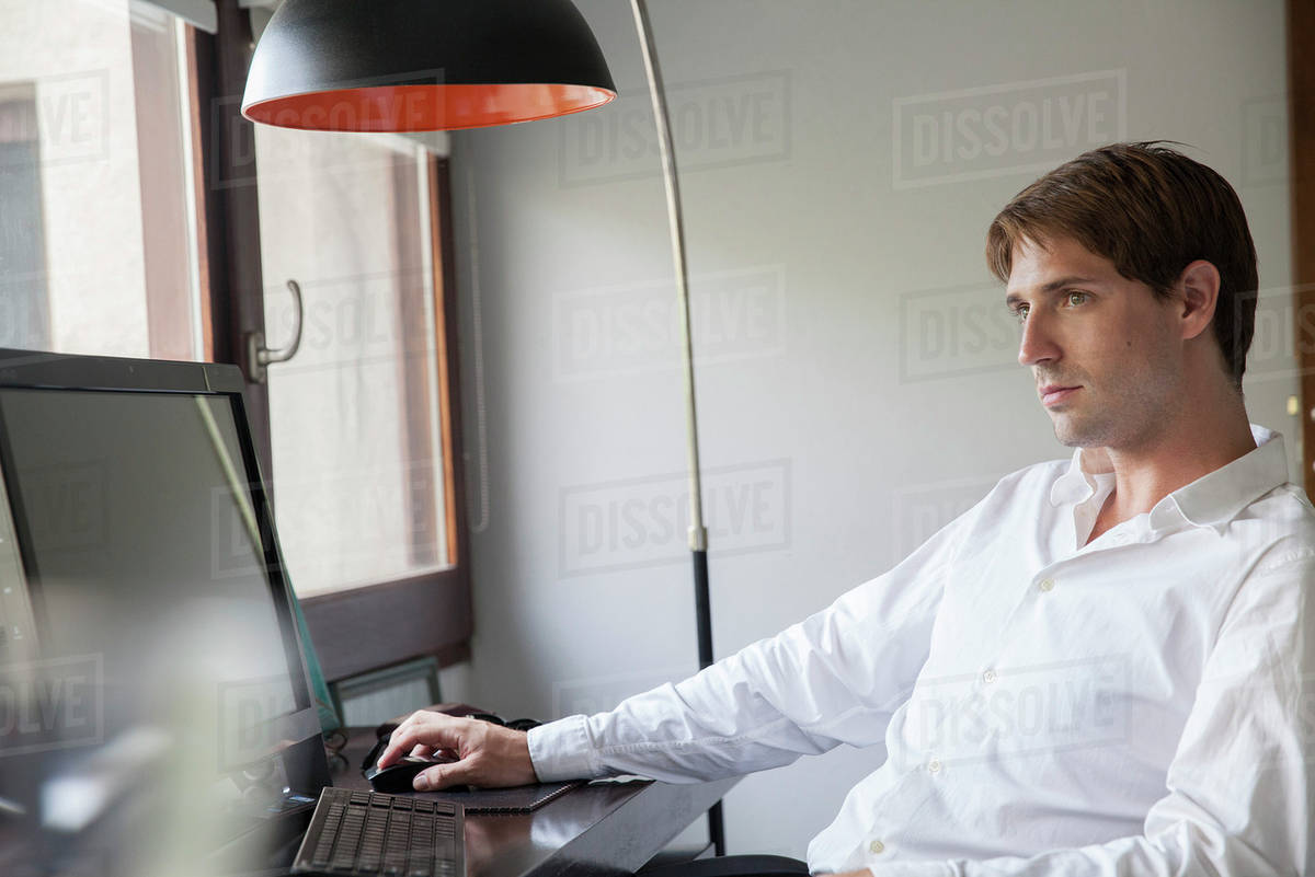 Man using desktop computer - Royalty-free Stock Photo | Dissolve