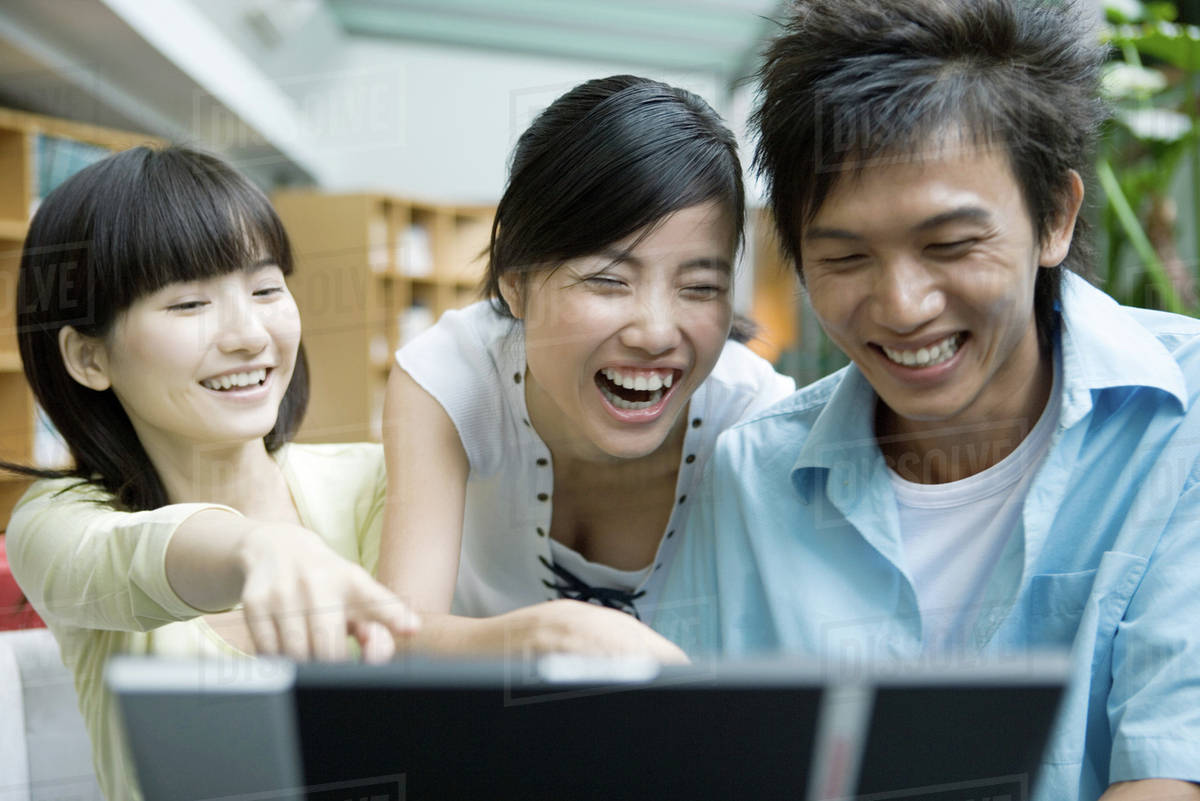 Three friends using computer, laughing - Royalty-free Stock Photo ...