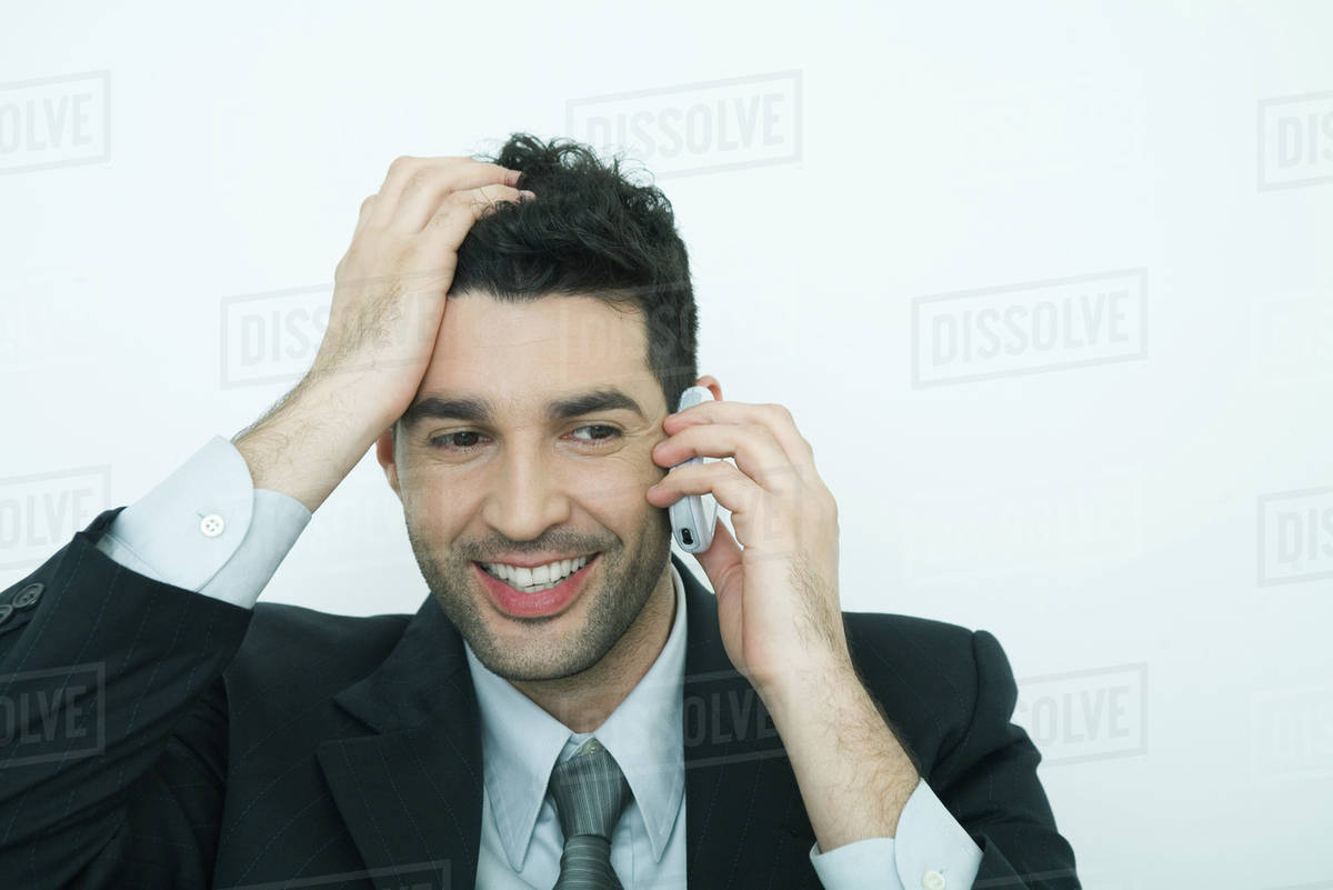 Businessman using cell phone, holding head - Royalty-free Stock Photo ...