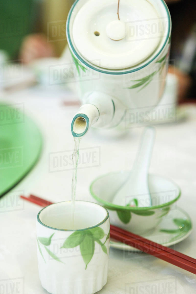 Pouring tea from teapot - Royalty-free Stock Photo | Dissolve