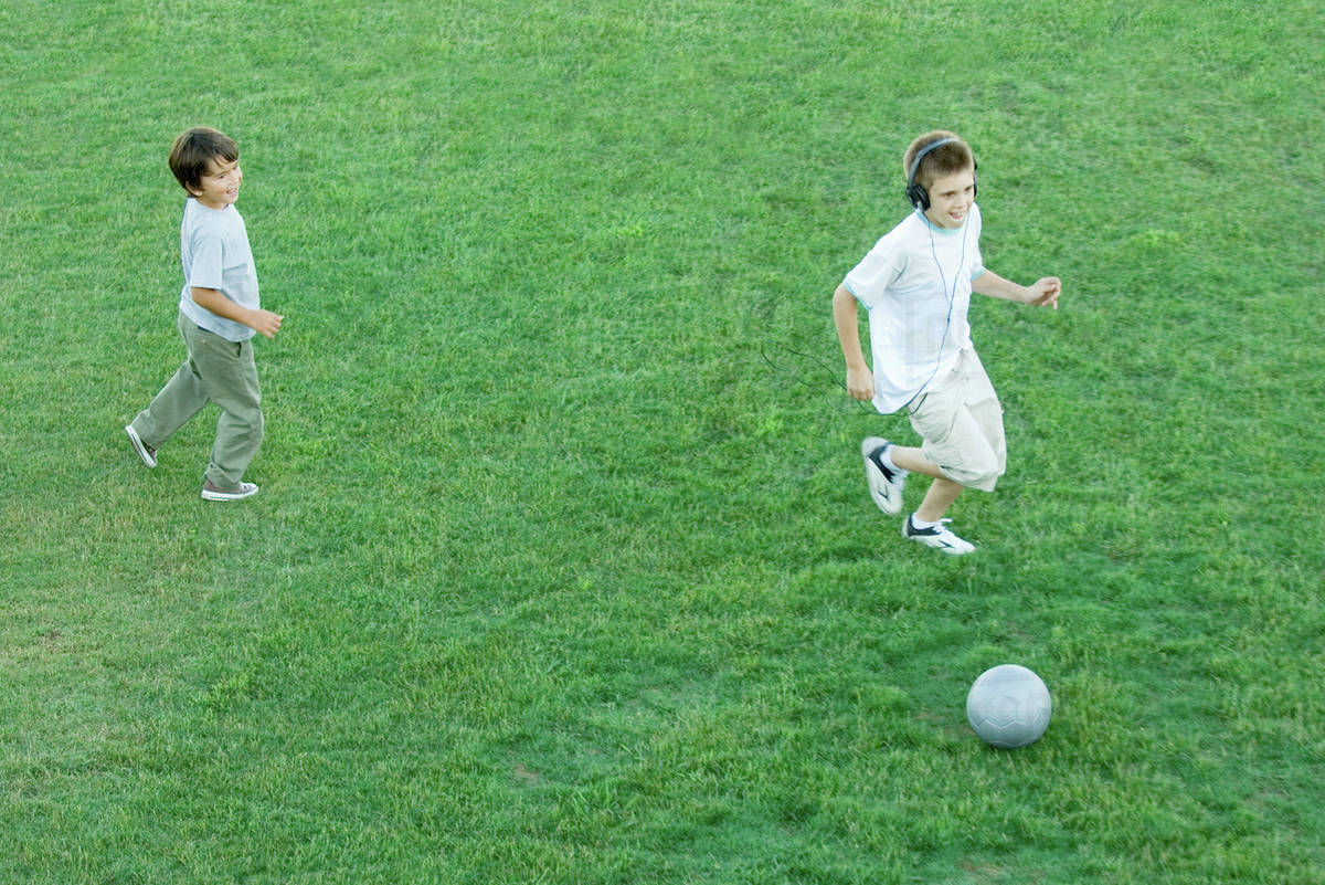 Two boys playing ball on lawn, high angle view - Royalty-free Stock ...