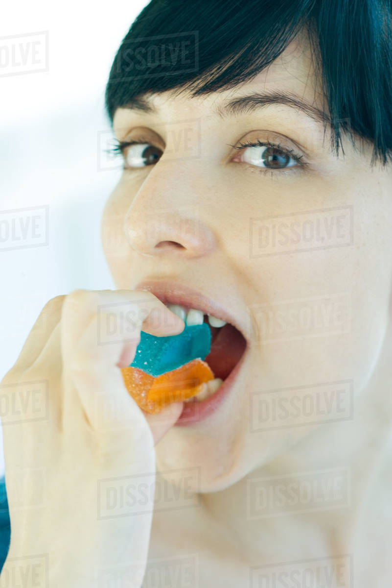 Woman eating candy - Royalty-free Stock Photo | Dissolve