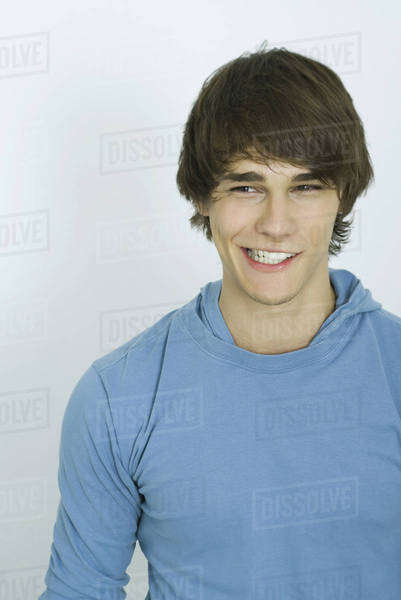 Teenage boy smirking, portrait - Royalty-free Stock Photo | Dissolve