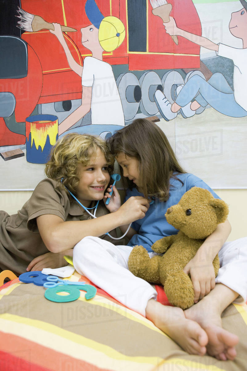 Boy and girl playing doctor - Royalty-free Stock Photo | Dissolve