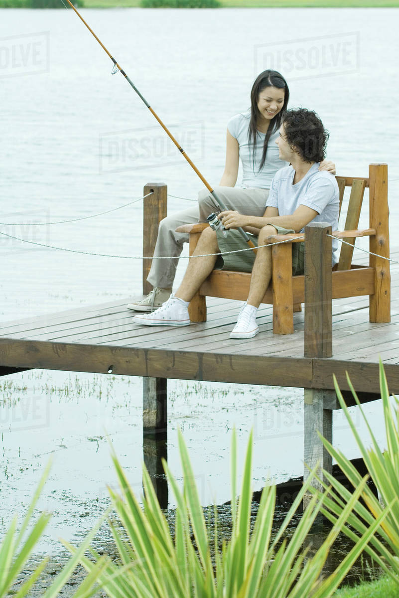 Couple fishing on pier - Stock Photo - Dissolve