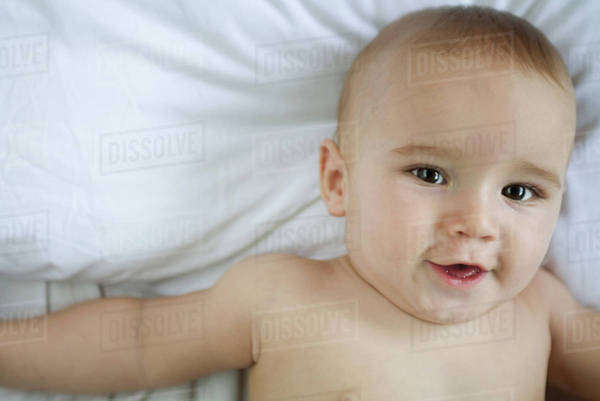Baby lying on back, looking at camera, head and shoulders - Royalty ...