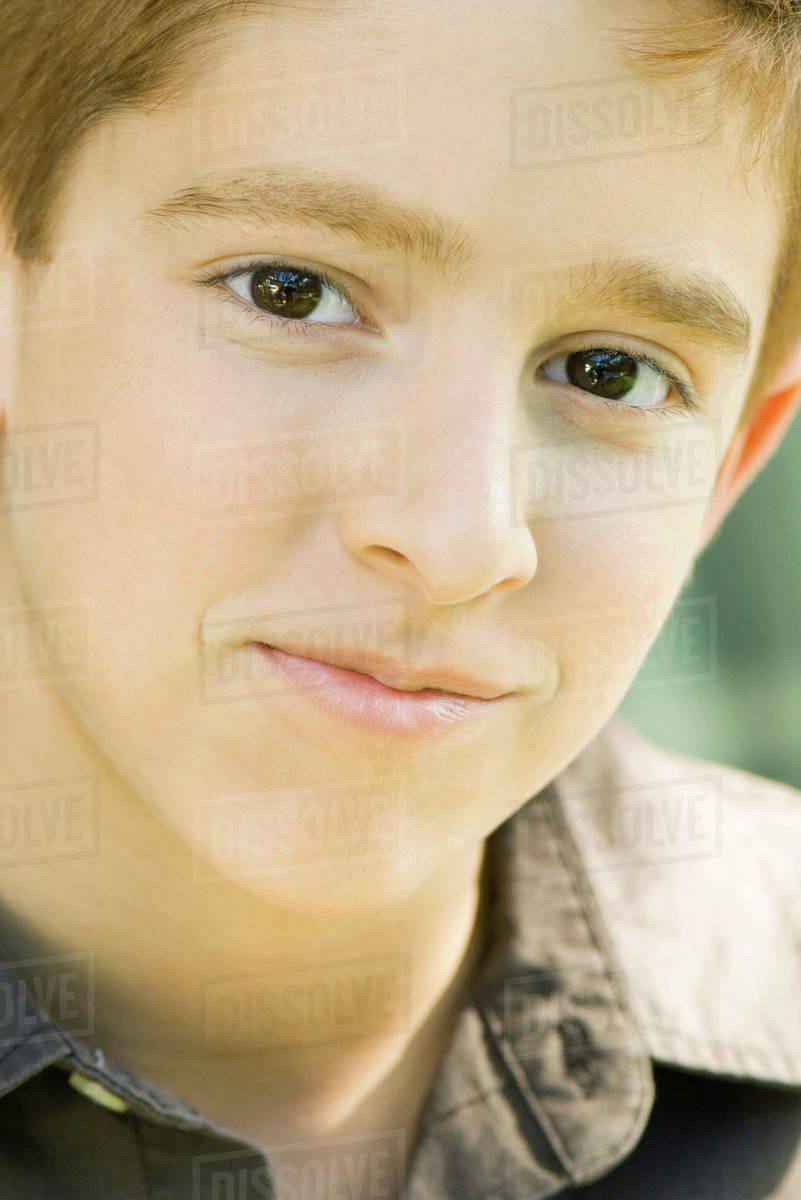 Boy smiling at camera, portrait - Royalty-free Stock Photo | Dissolve