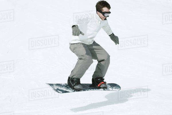 Snowboarder doing trick, full length - Stock Photo - Dissolve