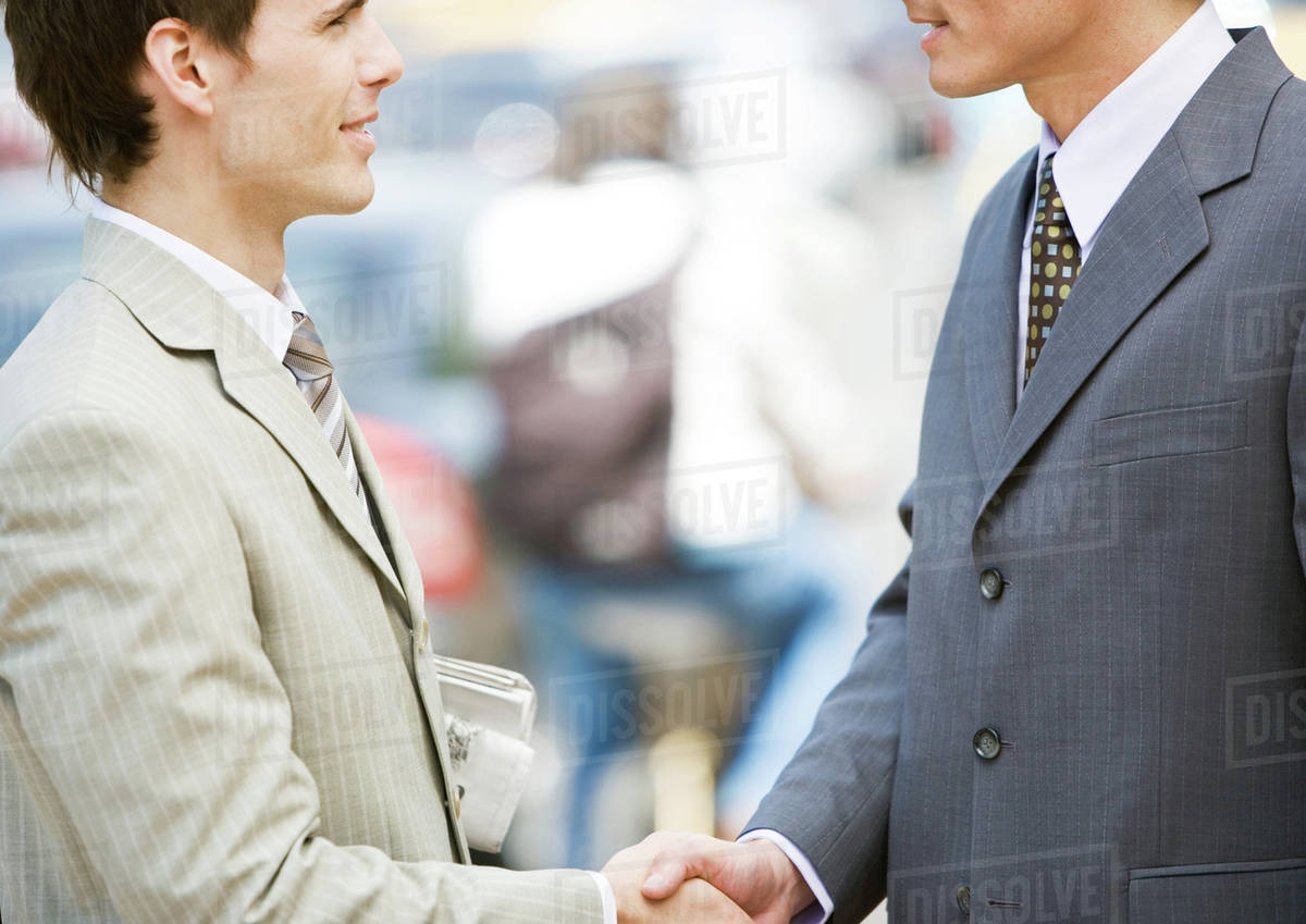 Two businessmen shaking hands - Royalty-free Stock Photo | Dissolve