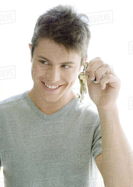 Man holding up keys - Royalty-free Stock Photo | Dissolve