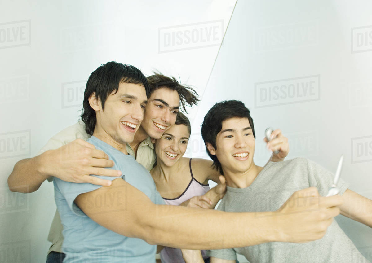 Taking group photo with cell phone - Royalty-free Stock Photo | Dissolve