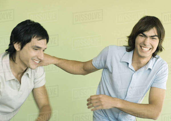 Two young men laughing - Stock Photo - Dissolve