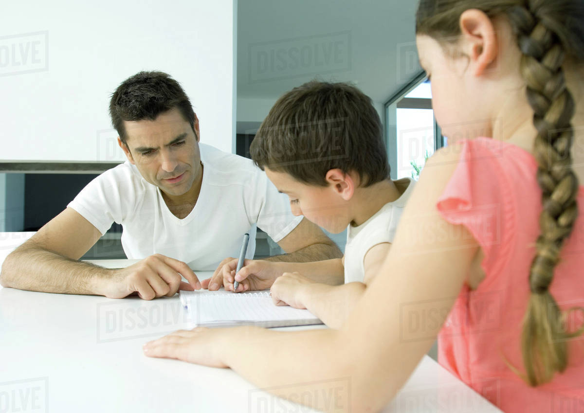 Father helping children with homework - Royalty-free Stock Photo | Dissolve