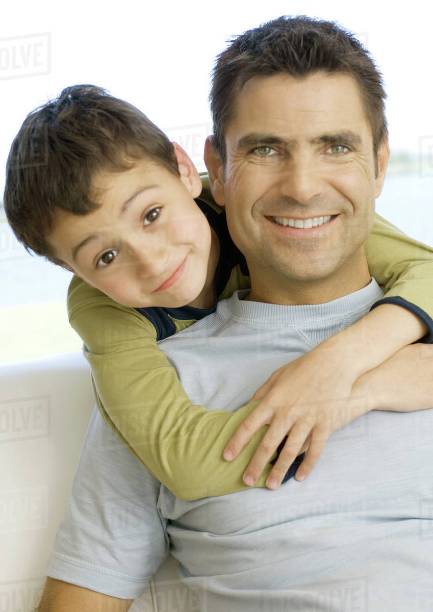 Boy hugging father from behind, portrait - Royalty-free Stock Photo ...