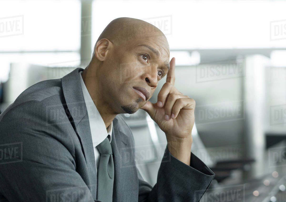 Businessman holding head and thinking - Stock Photo - Dissolve