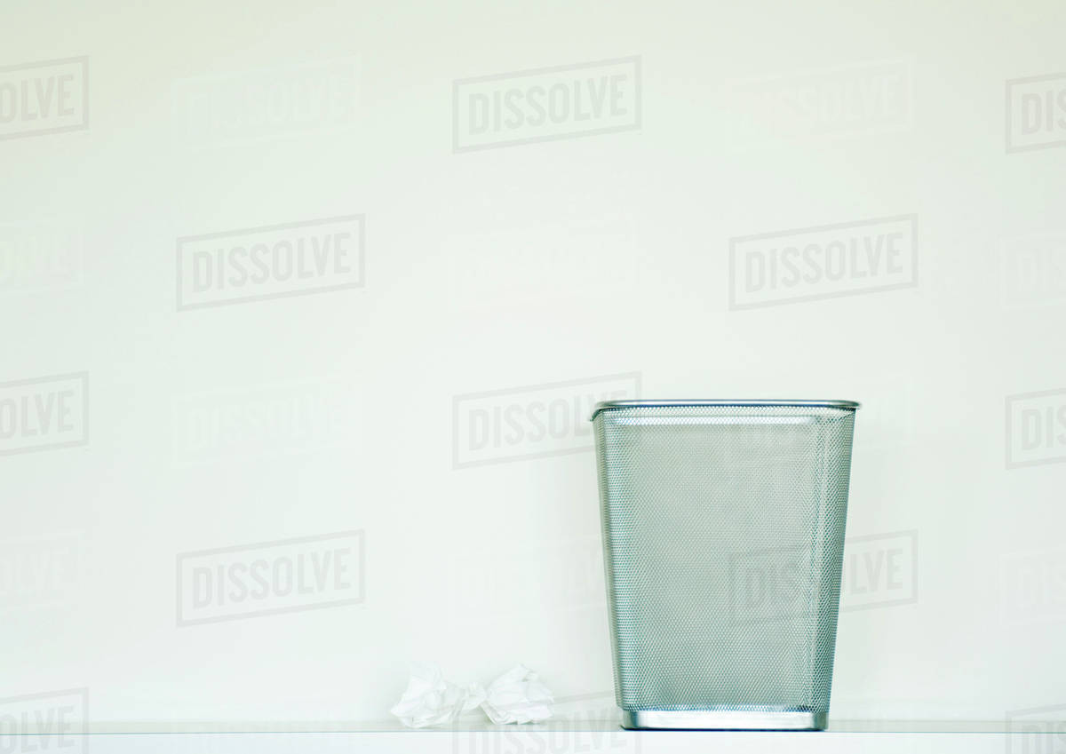 Empty wastepaper basket next to crumpled balls of paper - Stock Photo ...