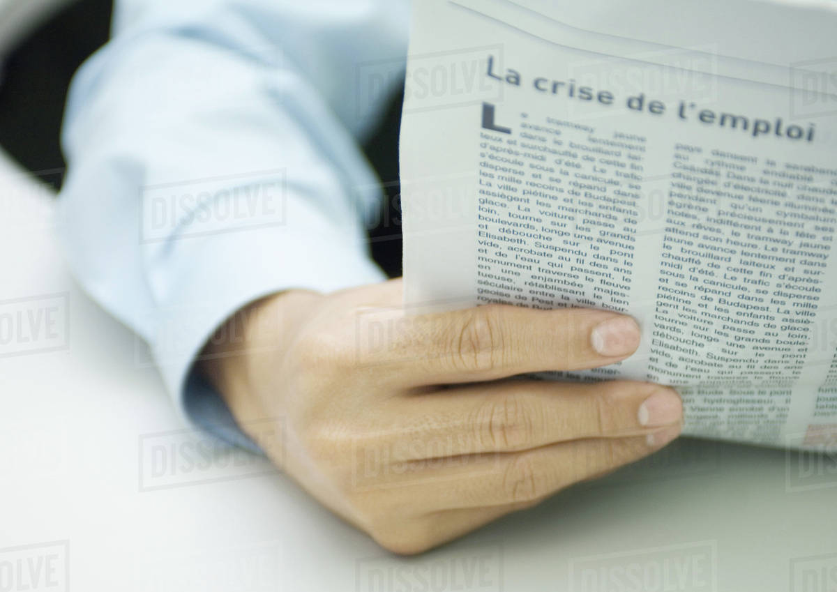 Man's hand holding newspaper - Royalty-free Stock Photo | Dissolve