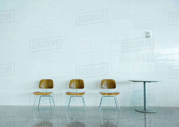 Three chairs in a row and a table - Royalty-free Stock Photo | Dissolve