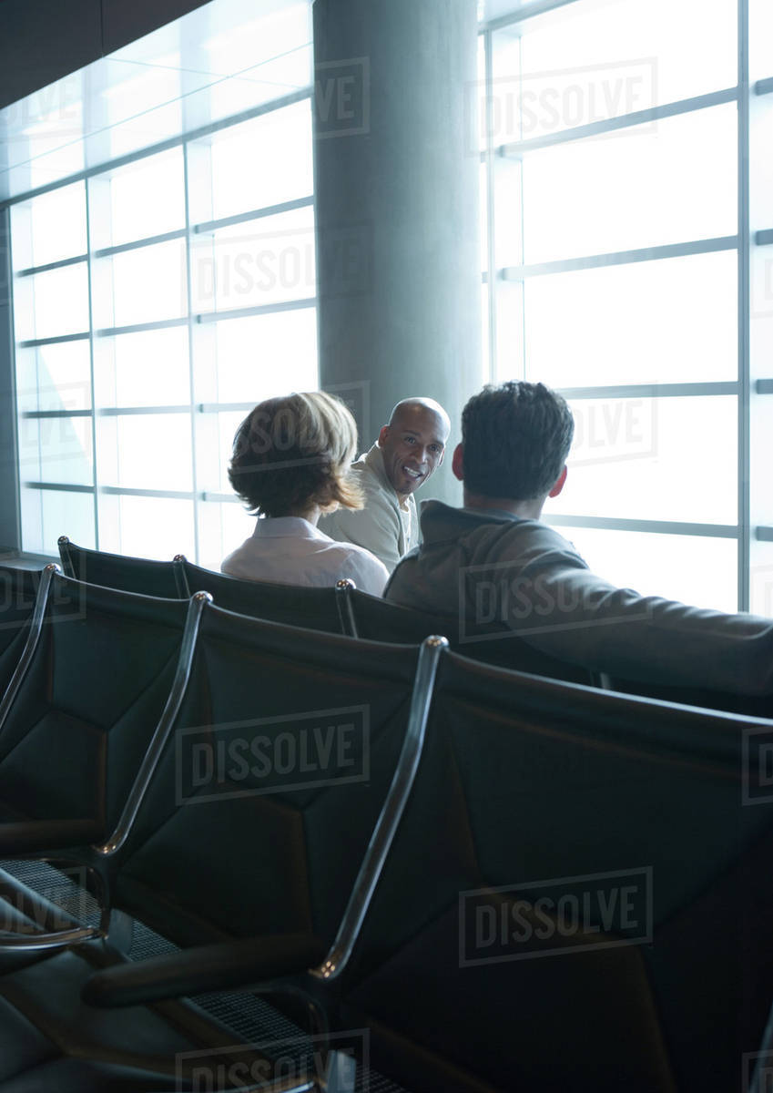 Travelers sitting in airport lounge - Stock Photo - Dissolve