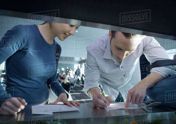 Two people filling in forms - Stock Photo - Dissolve