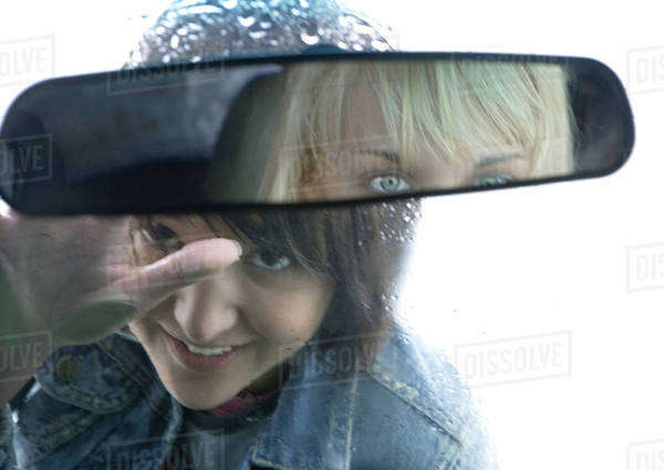 Young woman looking through windshield at female friend - Royalty-free ...