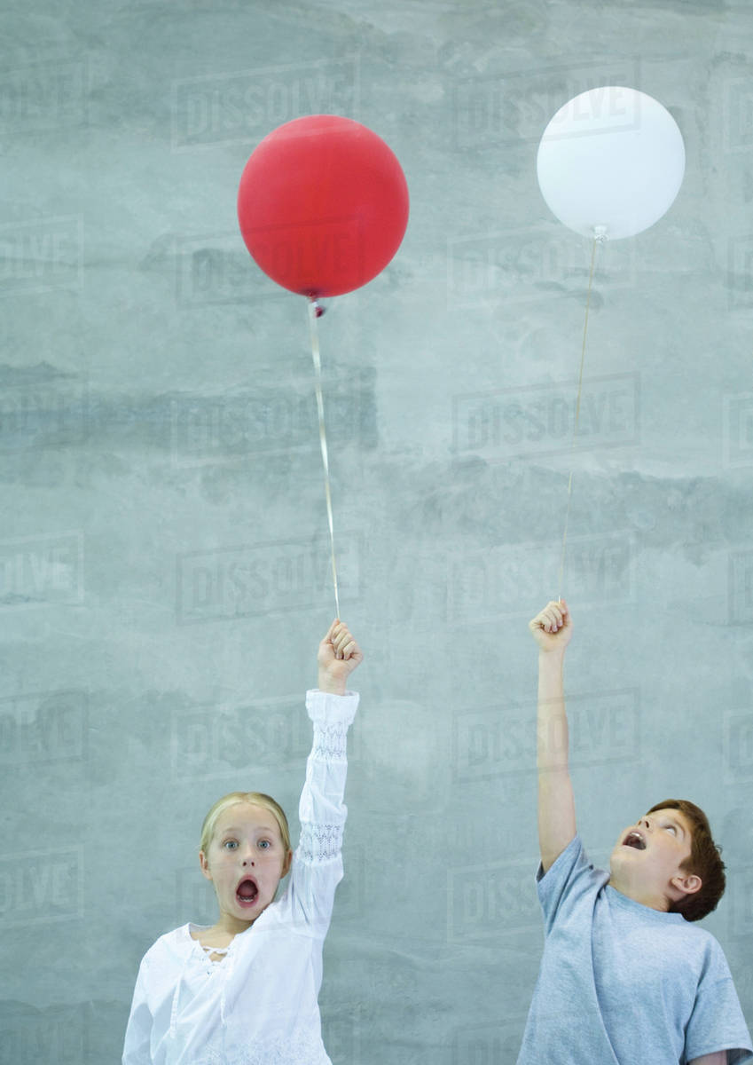 Two children holding balloons, shouting - Royalty-free Stock Photo ...