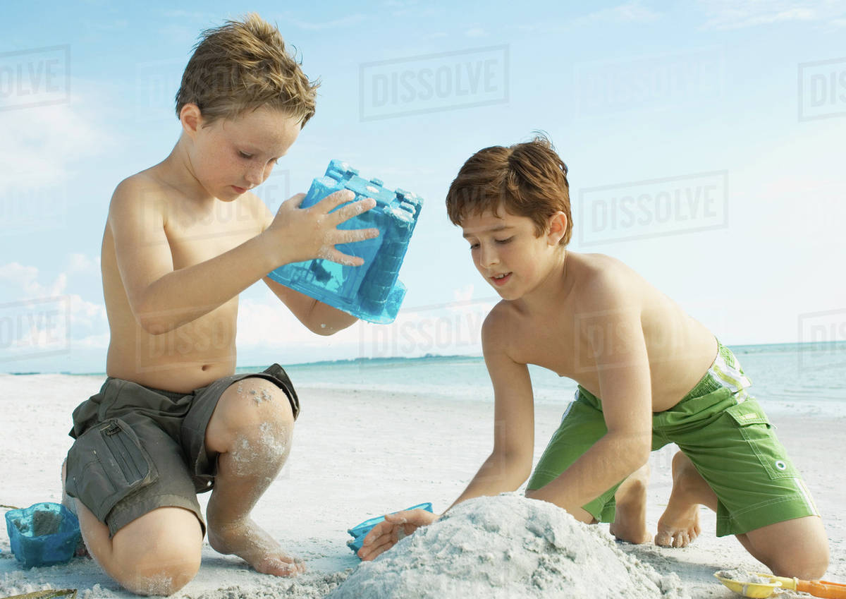 Boys building sand castle on the beach - Royalty-free Stock Photo ...