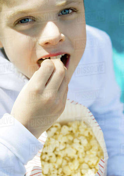Child eating popcorn - Royalty-free Stock Photo | Dissolve