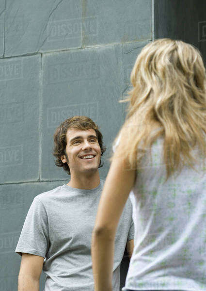 Young man and woman standing face to face - Royalty-free Stock Photo ...