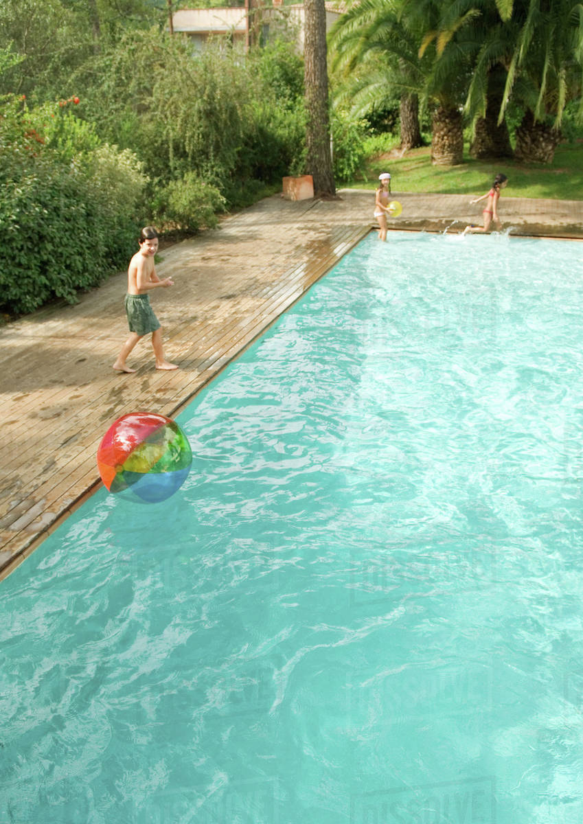 Children playing around swimming pool - Royalty-free Stock Photo | Dissolve