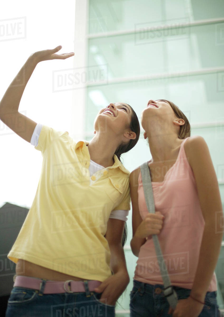 Teen girls looking up - Royalty-free Stock Photo | Dissolve