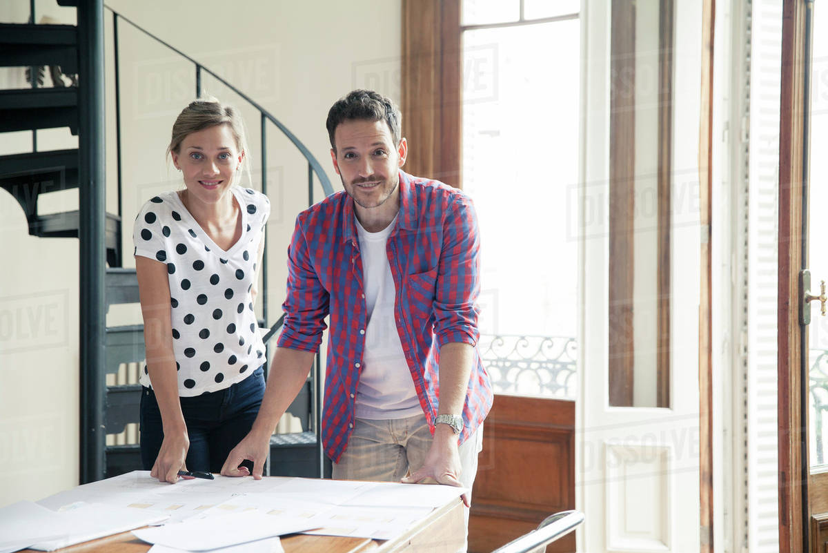 Design team reviewing blueprints - Royalty-free Stock Photo | Dissolve
