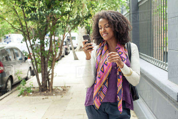 Woman using cell phone - Stock Photo - Dissolve