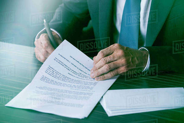 Executive signing document - Royalty-free Stock Photo | Dissolve