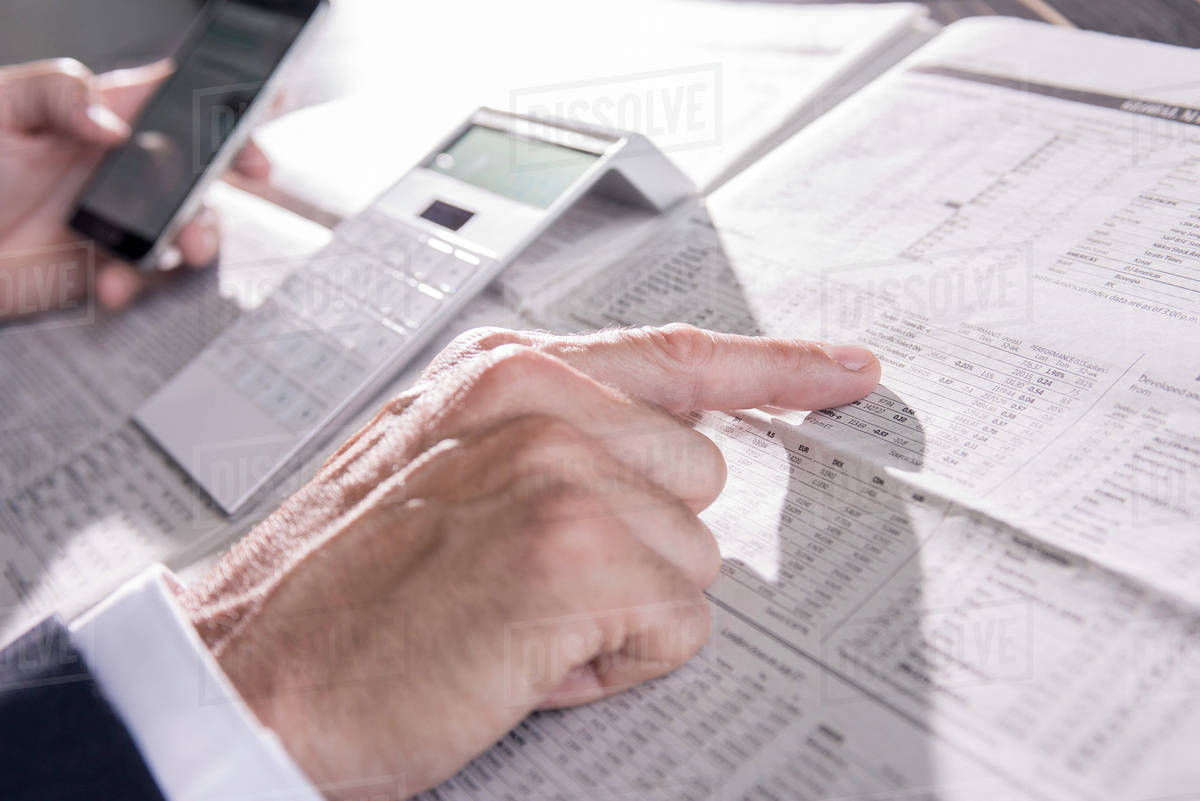 Checking stock market performance in newspaper - Royalty-free Stock ...