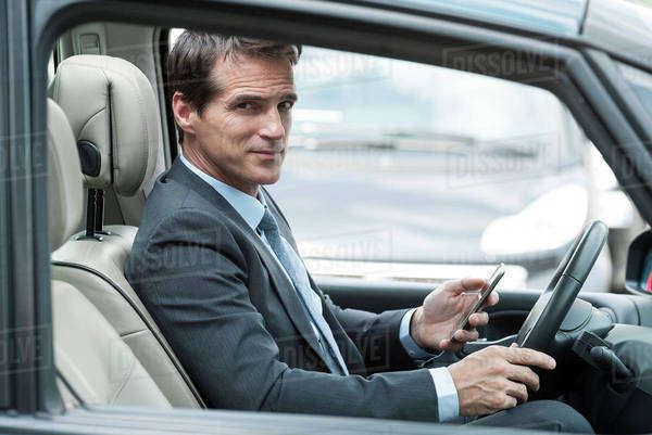 Man texting while driving car - Royalty-free Stock Photo | Dissolve