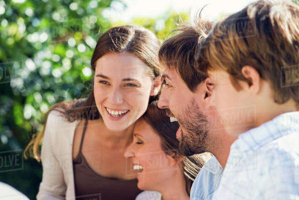 Family laughing together outdoors - Royalty-free Stock Photo | Dissolve