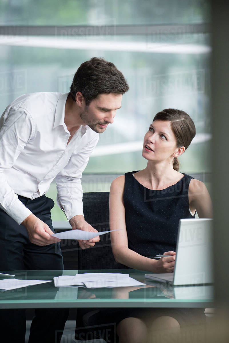 Office workers collaborating on project - Stock Photo - Dissolve
