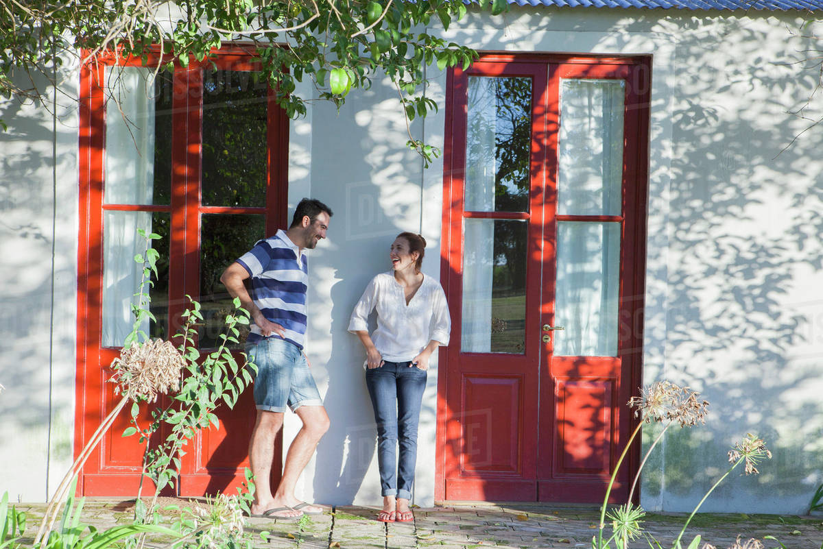 Neighbours chatting outside duplex - Stock Photo - Dissolve
