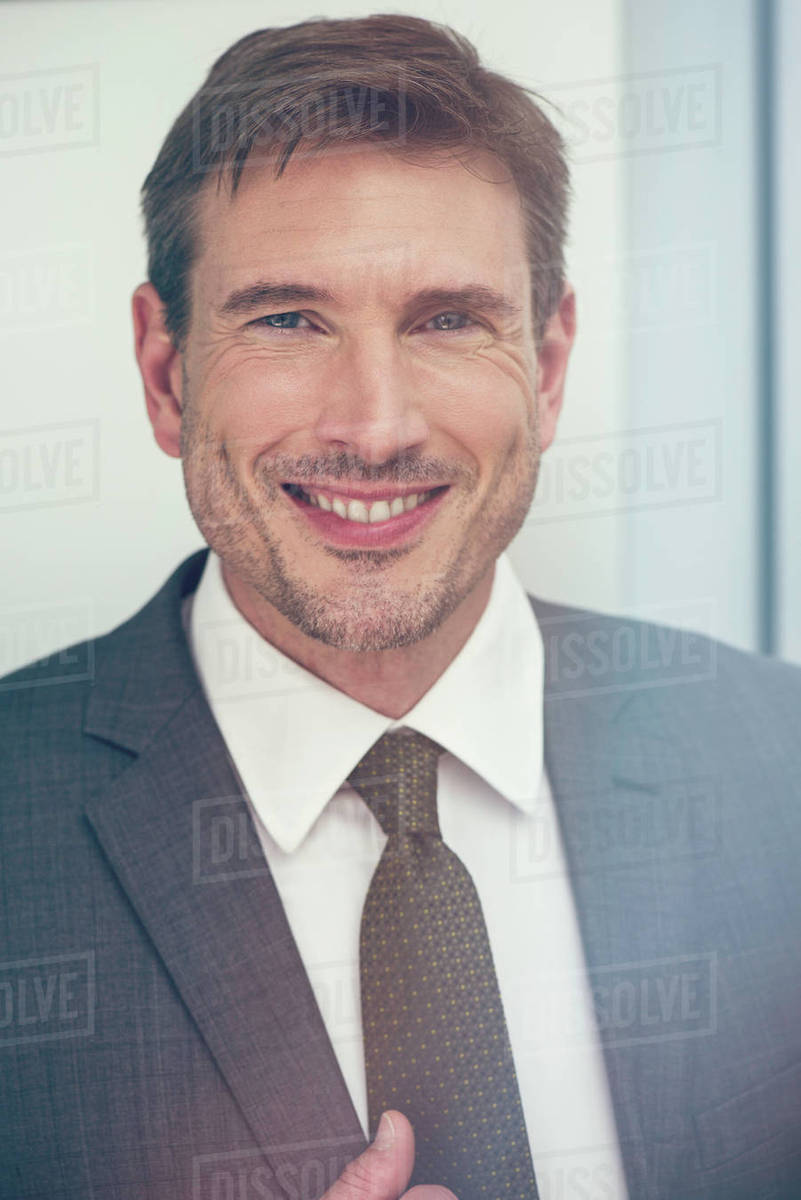 Businessman smiling, portrait - Royalty-free Stock Photo | Dissolve